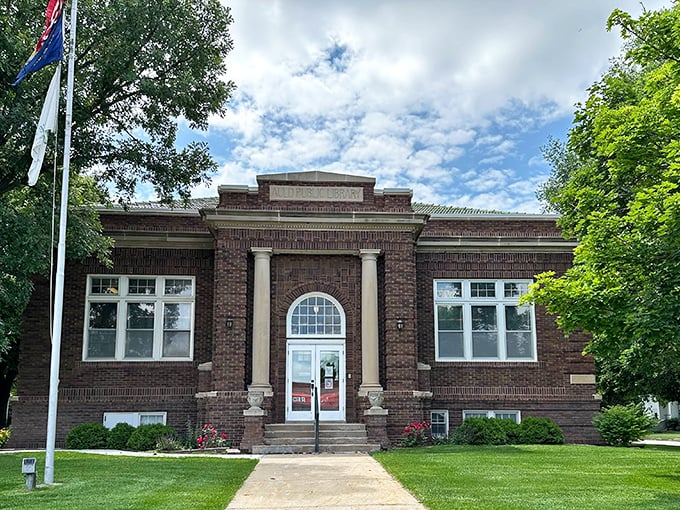 The Auld Public Library stands as a temple to knowledge, its classical columns and brick facade housing stories both on shelves and in its very walls.