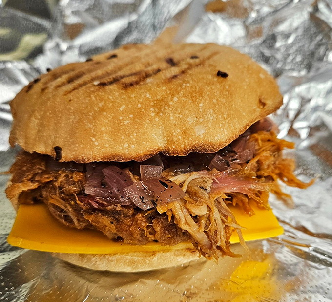 This pulled pork sandwich isn't messing around. It's the kind of serious comfort food that demands both napkins and respect.