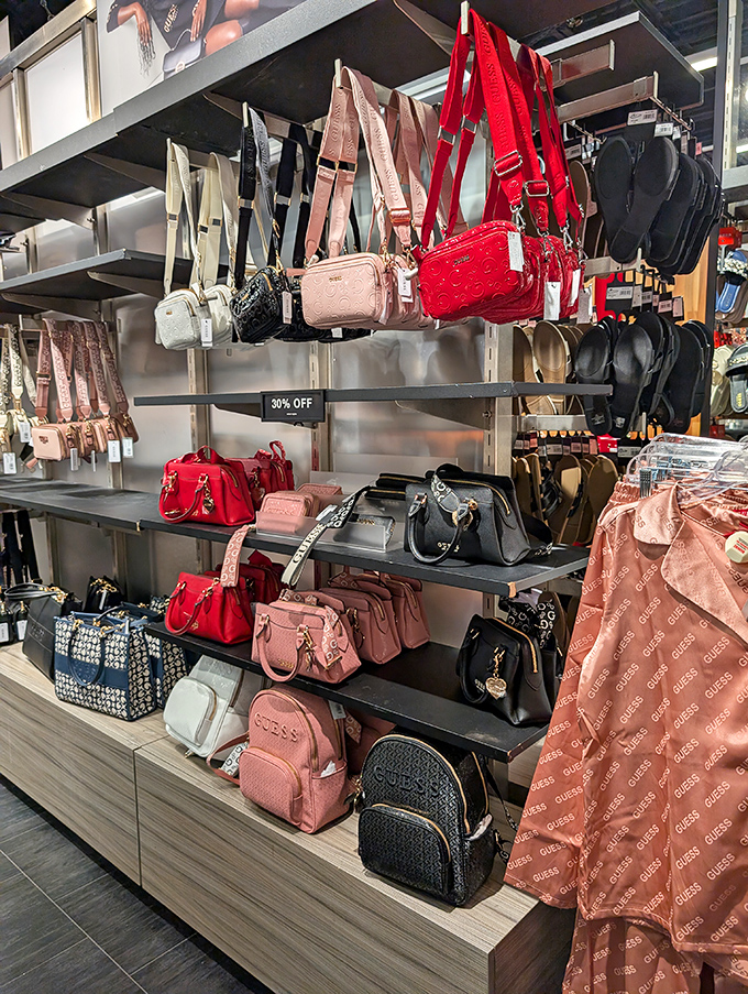 A rainbow of GUESS handbags stands ready to tempt shoppers with the promise of designer style at non-designer prices.