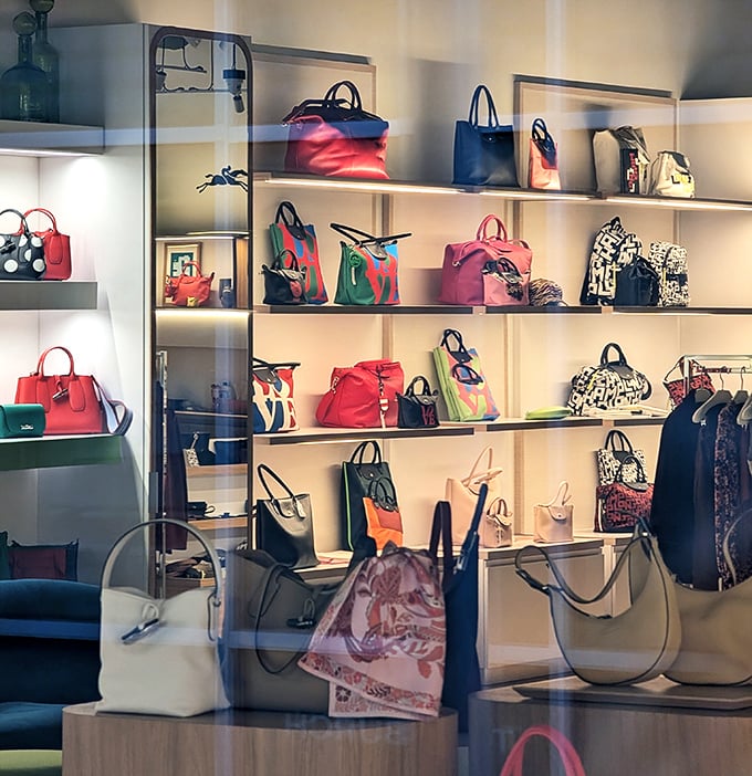 Handbag heaven where designer dreams come true at outlet prices. Each colorful creation practically whispers, "Take me home and make your friends jealous."