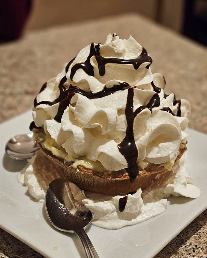 This isn't just dessert, it's architecture&mdash;a towering banana cream tart where whipped cream meets chocolate in a sweet skyscraper.