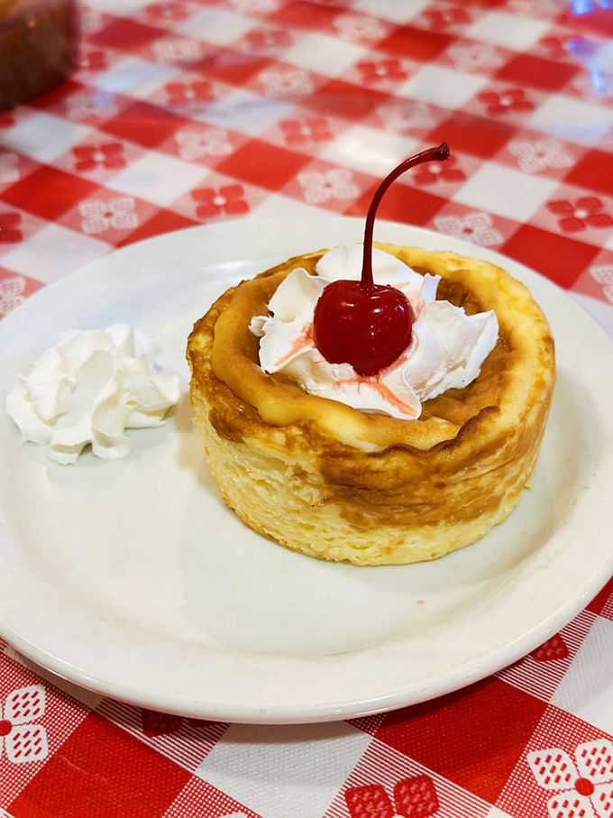 Basque cheesecake crowned with a cherry&mdash;creamy, caramelized perfection that makes you forget calories exist.