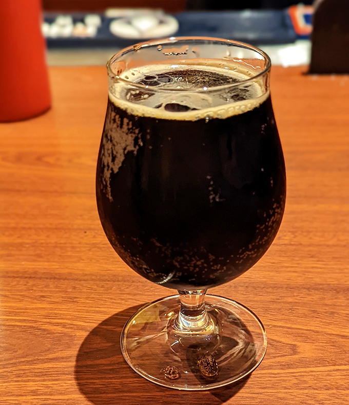 A proper craft beer in a proper glass&mdash;because sometimes adulting has its privileges, especially when paired with creative hot dogs.