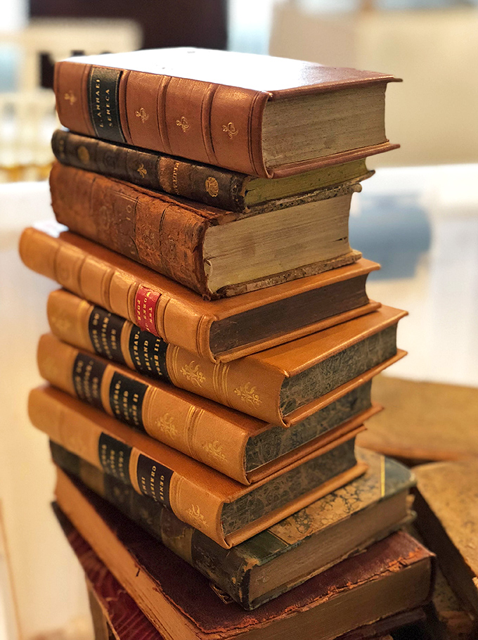 A tower of leather-bound wisdom that smells like history and grandpa's study. Books that were meant to be read, not just displayed on Zoom calls.