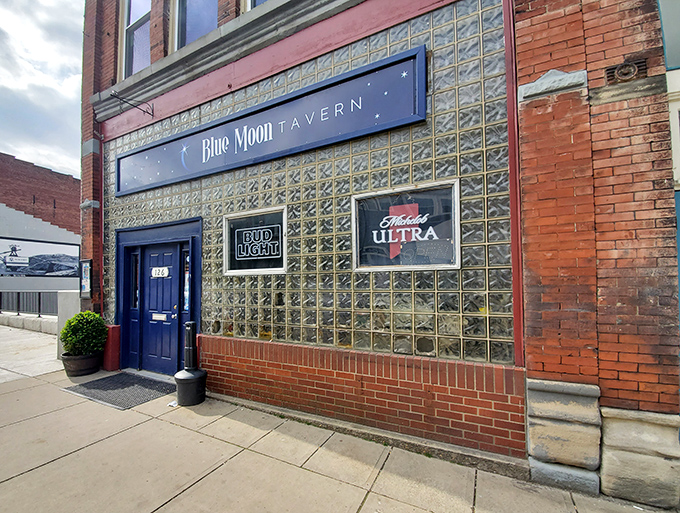 The Blue Moon Tavern's glass block facade gleams like a disco ball's sophisticated cousin&mdash;promising cold drinks and warm conversations inside.