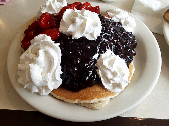 Blueberry pancakes crowned with whipped cream and fruit compote. The kind of breakfast that makes you want to high-five the chef and hug your server.