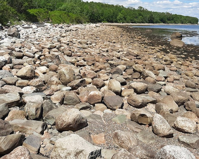 Rounded boulders carpet the shore like nature's own cobblestone street, minus the uncomfortable shoes and tourist crowds everywhere.