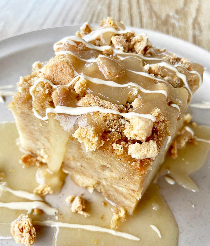 Bread pudding dressed in praline sauce like it's heading to Mardi Gras – decadent, unapologetic, and absolutely necessary.