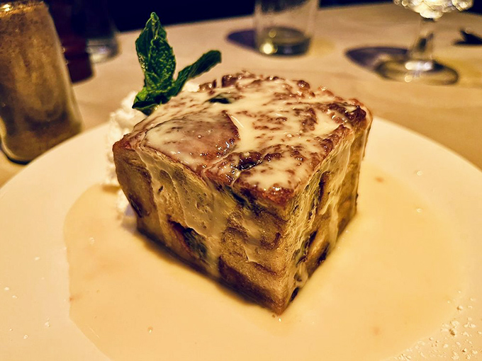 Not just bread pudding&mdash;a architectural marvel of custard-soaked decadence swimming in a sauce that would make angels weep. Grandma would approve.
