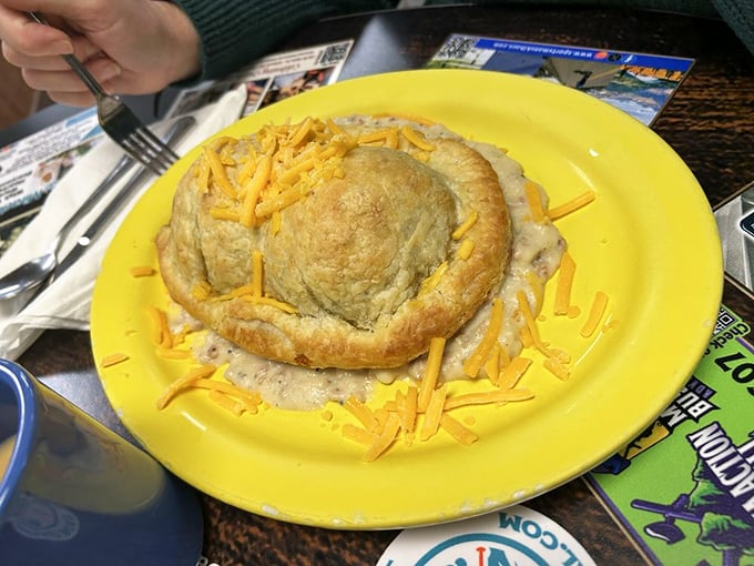 Breakfast engineering that defies gravity! This golden-crusted pastry dome surrounded by cheese is what happens when breakfast gets architectural ambitions.