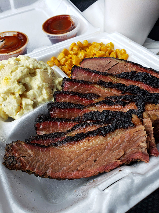 Brisket sliced thick with a bark that means business. That perfect pink smoke ring is the BBQ equivalent of a Michelin star.