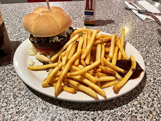 This isn't just a burger&mdash;it's a towering monument to American ingenuity, flanked by golden fries that could make a French chef weep with envy.