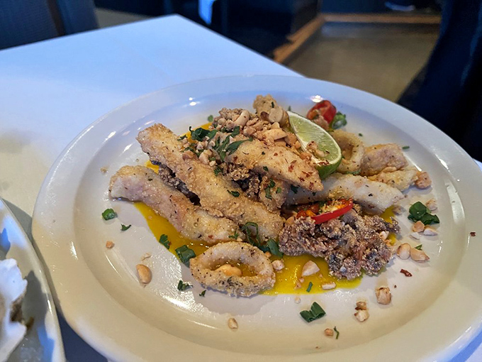 Crispy calamari elevated with nuts and microgreens. Not your average bar food&mdash;this is squid that went to finishing school.