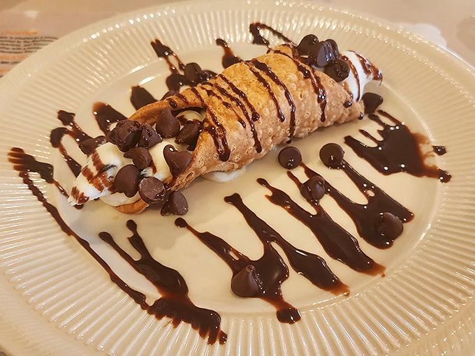 The cannoli—crisp shell, creamy filling, chocolate drizzle—a dessert so perfect it makes you want to leave the gun and take the pastry.