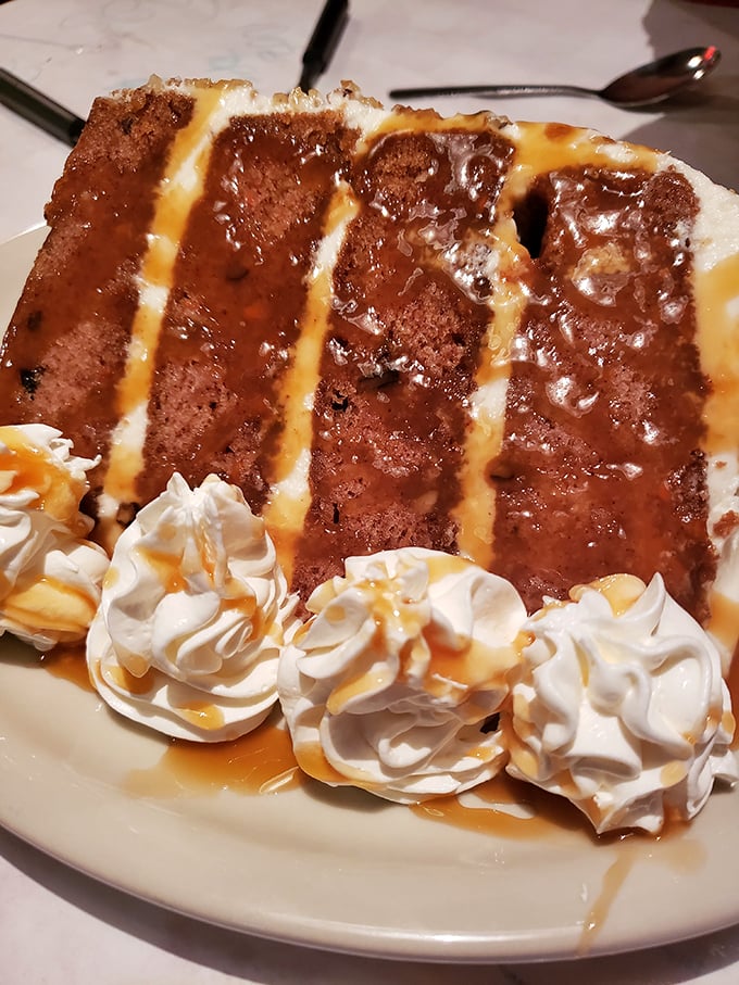 This carrot cake isn't just dessert—it's an architectural marvel of moist layers, cream cheese frosting, and caramel drizzle that demands to be savored.