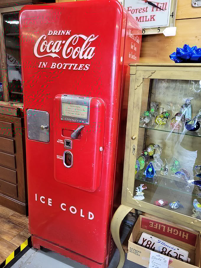 The vintage Coca-Cola vending machine stands as a red sentinel of refreshment, a time when five cents bought happiness in a glass bottle.