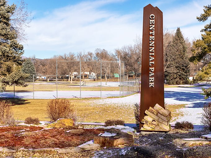 Centennial Park's sign stands tall against a winter backdrop &ndash; the kind of place where community happens and kids still actually play outside.