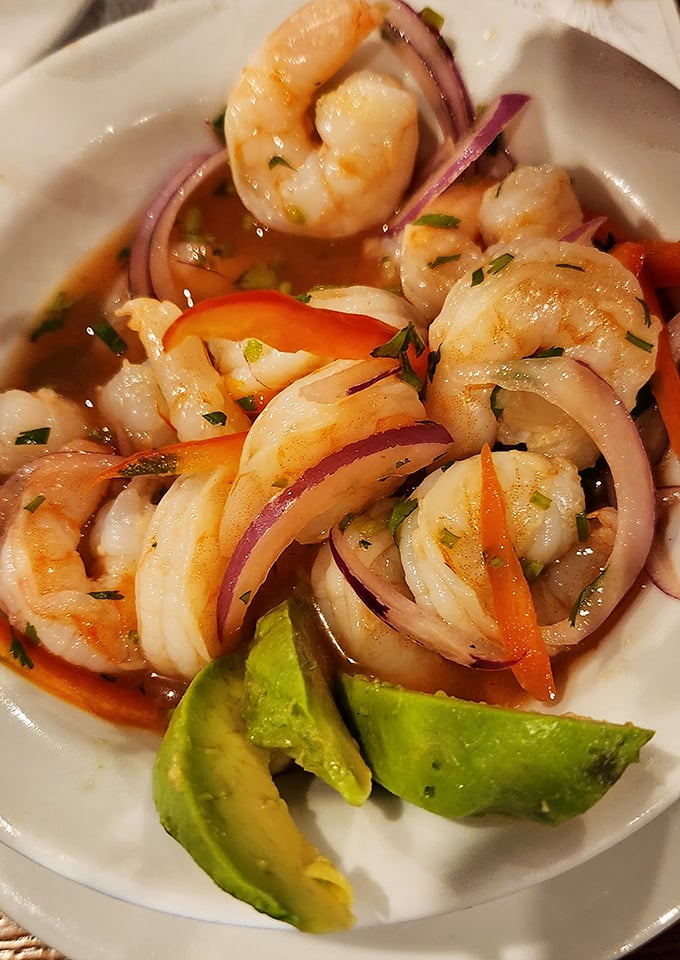 Ceviche de Camarones: where plump shrimp swim in citrus marinade alongside red onions and avocado. The ocean's finest moment on a plate.