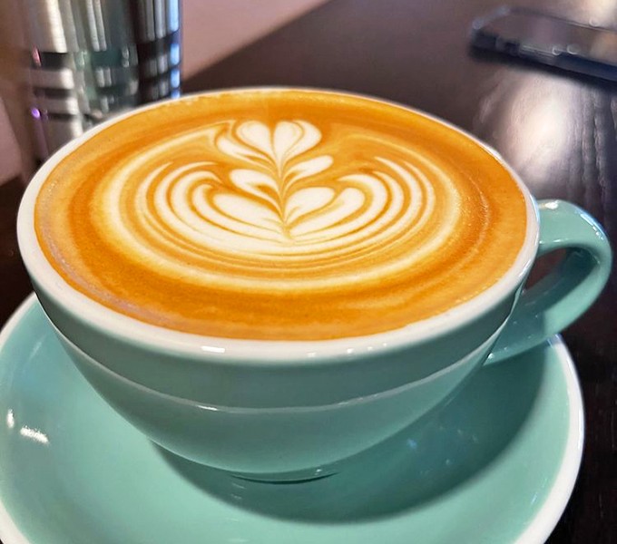 Latte art so pretty you almost don't want to drink it. Almost. The turquoise cup adds that extra touch of morning joy.