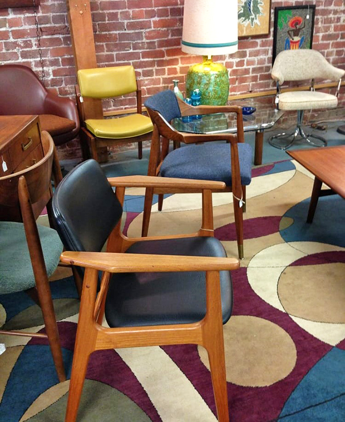 Mid-century modern heaven against exposed brick. These wooden chairs aren't just furniture&mdash;they're sculptures that happen to be comfortable for human posteriors.