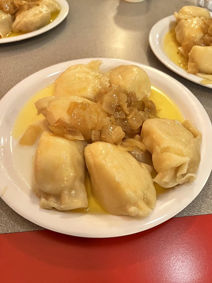 Pierogies lounging in butter like they're at a day spa. These plump pockets of potato and cheese are practically begging to be devoured.