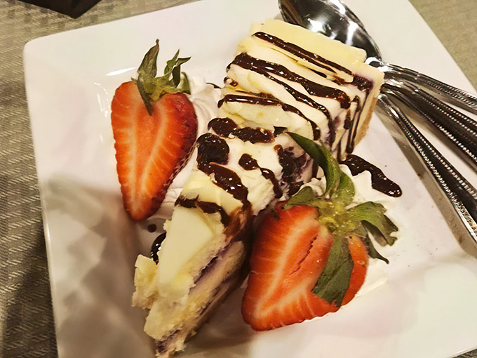 Cheesecake with chocolate drizzle and fresh strawberries &ndash; because after conquering a steak, you deserve a victory dessert that's equally impressive.