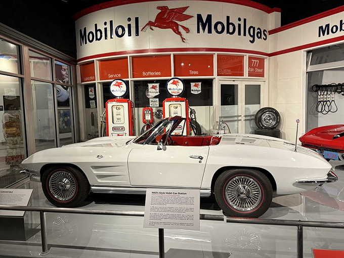The vintage Mobilgas station provides the perfect backdrop for this pristine white Corvette, creating a time capsule of American automotive optimism.