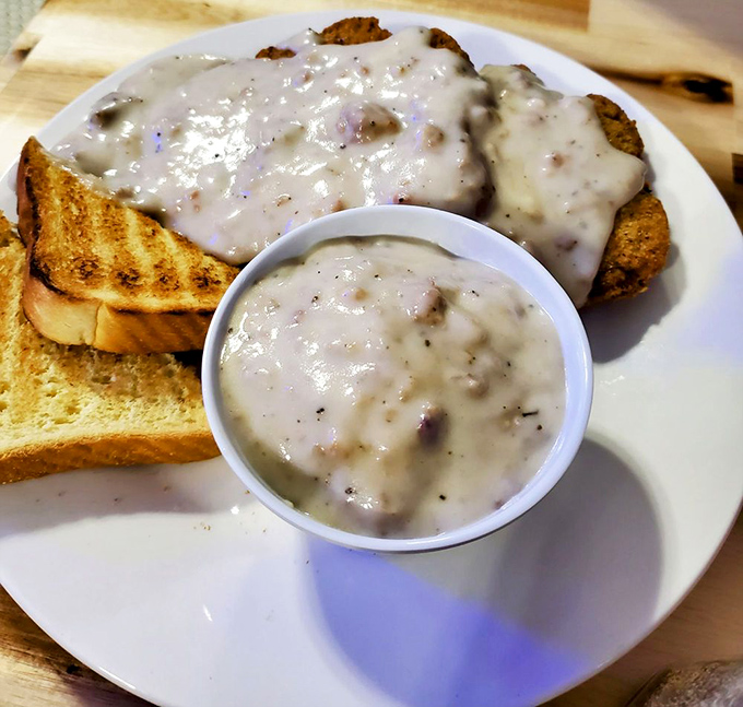 Biscuits swimming in peppery gravy alongside golden toast &ndash; the breakfast equivalent of a warm hug on a cold morning.