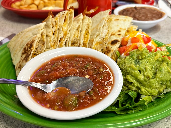 Fresh quesadillas served with the holy trinity of New Mexican condiments: salsa, guacamole, and enough cheese to make Wisconsin nervous.