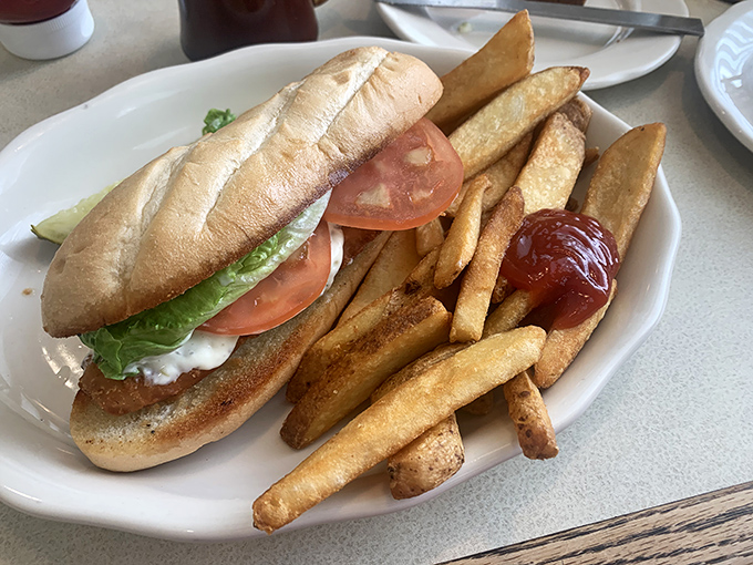 A sandwich that understands the importance of proper french fry-to-plate ratio. This isn't just lunch—it's architecture with a side of ketchup.