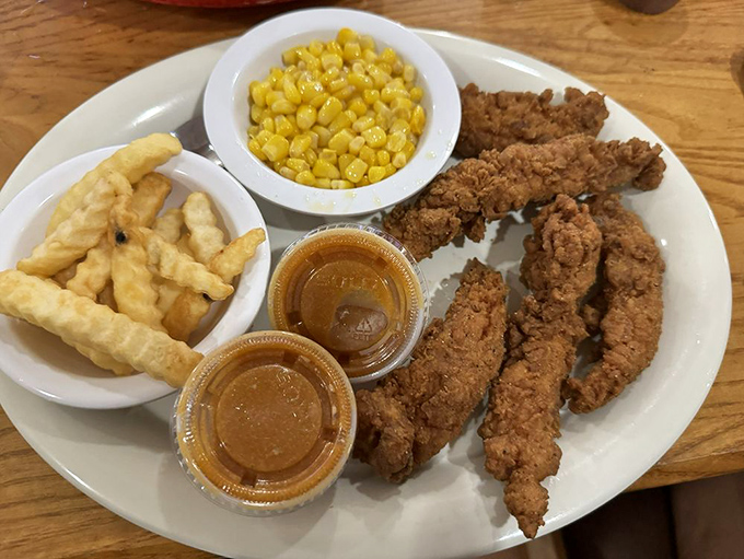 Chicken tenders that actually deserve the name "tender," served with creamy mashed potatoes and sweet corn that tastes like summer decided to stay for dinner.