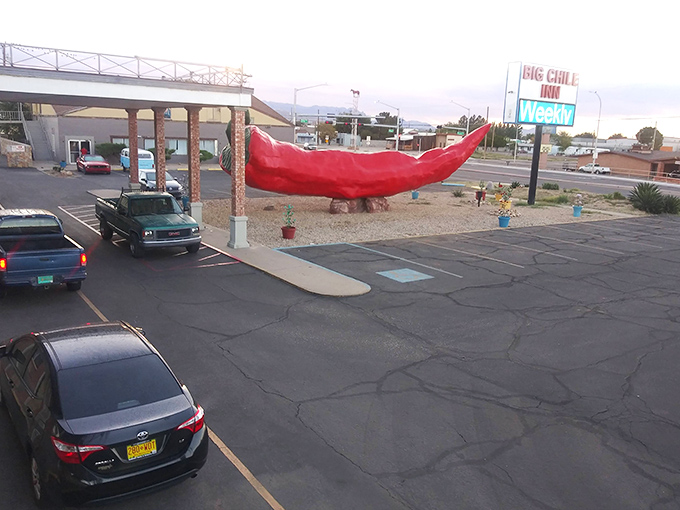 The parking lot view reveals how the massive pepper dominates its surroundings, a spicy landmark that makes "turn at the giant chile" perfect directions.