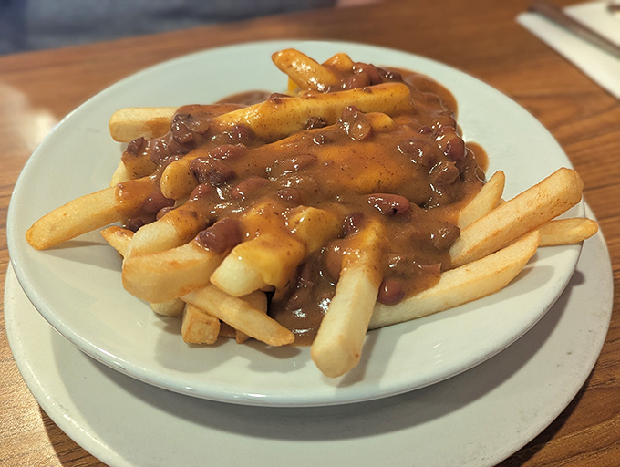 Chili cheese fries: where dignity goes to die and happiness begins. A beautiful mess that requires both a fork and absolutely zero regrets.