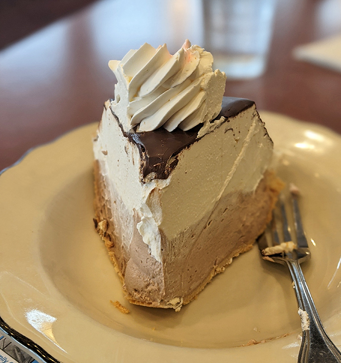 This slice of chocolate cream pie isn't just dessert &ndash; it's therapy on a plate, with layers of silky filling that would make a pastry chef blush with envy.