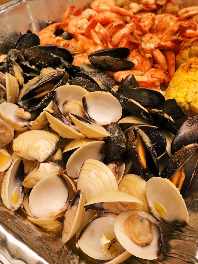 The shellfish section of the buffet—where clams and mussels gather like tiny treasures from Neptune's vault, waiting to deliver their briny perfection.