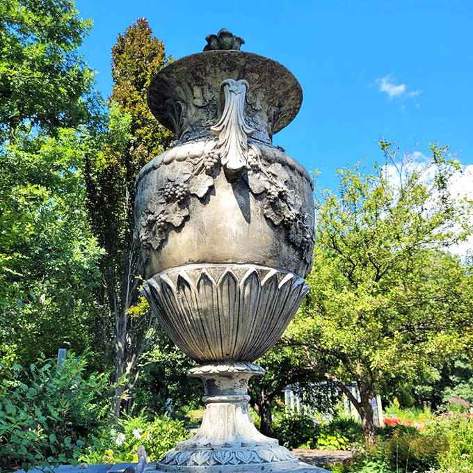 This classical garden urn has witnessed more seasons than most of us have had hot dinners, yet still stands with more dignity than I manage on Monday mornings.