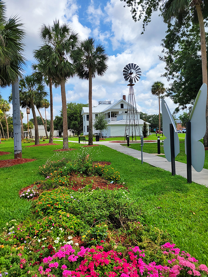 Palm trees and colorful gardens frame this decorative windmill, a whimsical touch in a town that knows how to blend history with playfulness.