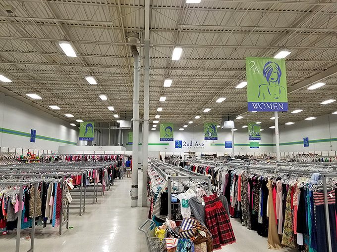 An ocean of clothing possibilities under industrial lighting. The thrill of the hunt keeps shoppers coming back weekly.