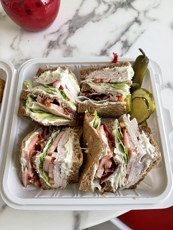 The club sandwich&mdash;stacked higher than some LA apartment buildings and requiring both hands, strategic planning, and absolutely no regrets.