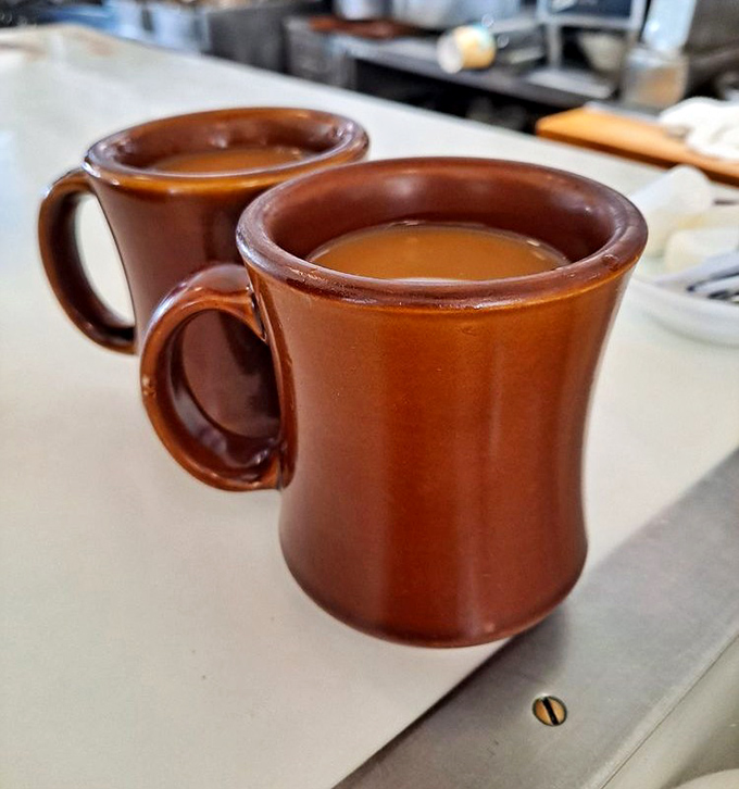 Those sturdy brown mugs mean business. No skinny lattes here&mdash;just honest coffee that tastes like it was made by someone who understands morning struggles.