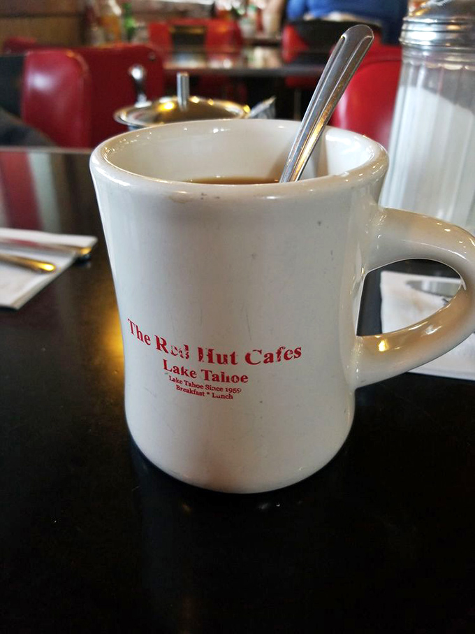 That sturdy coffee mug says everything about Red Hut's philosophy: no-nonsense, reliable, and ready to be refilled whenever you give the nod.