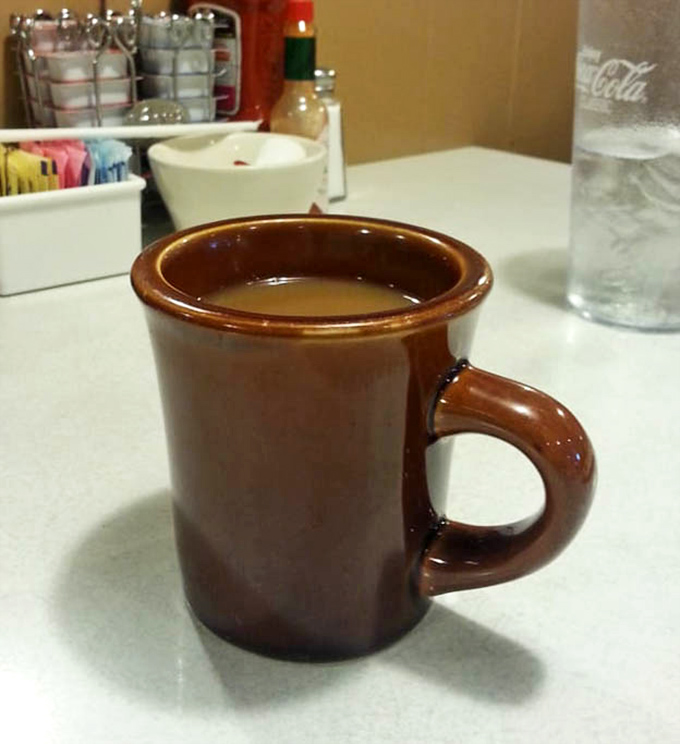 That sturdy brown diner mug isn't just holding coffee&mdash;it's holding liquid optimism, the unsung hero of every great breakfast experience.