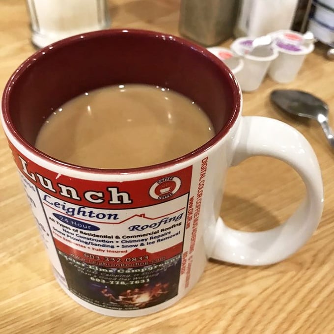 The coffee mugs at Linda's advertise local businesses &ndash; because nothing says "community" like caffeinating while supporting your neighborhood roofer.