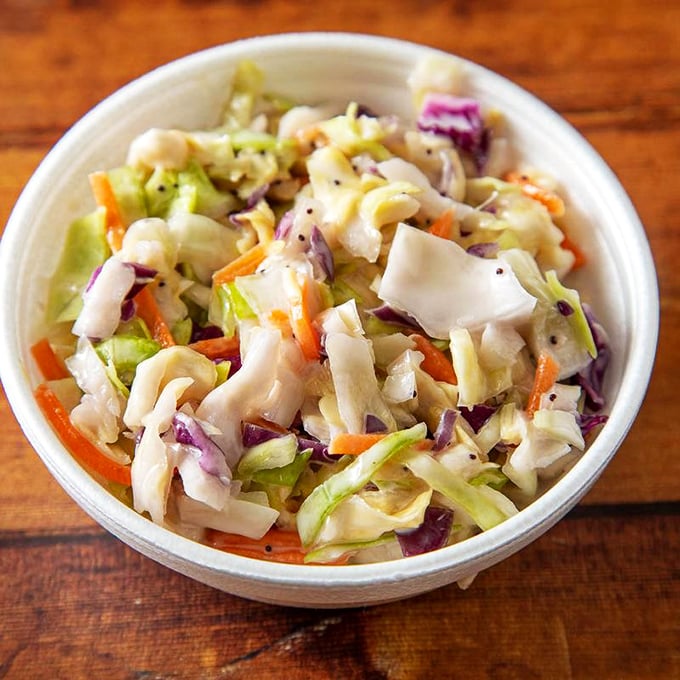 The coleslaw provides the perfect cool, crisp counterpoint to the hot chicken. Like finding shade on a New Orleans summer day.
