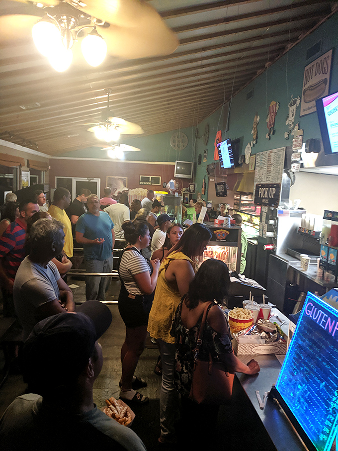 Intermission rush! The concession stand becomes command central between features, serving up everything from popcorn to pizza with nostalgic flair.