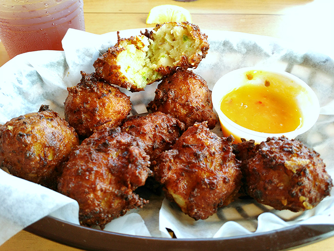 Golden-fried conch fritters with dipping sauce&mdash;little flavor bombs that transport you to island time with each bite.