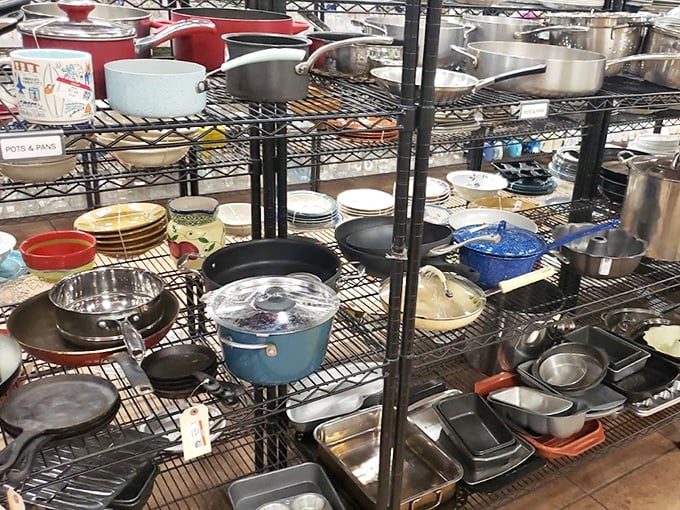 Cookware paradise! That blue enamel pot might have simmered someone's award-winning chili before finding its way to your kitchen.