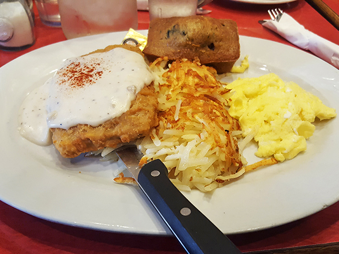 The Country Style Benny: where buttermilk biscuit meets sausage, eggs, and country gravy in a breakfast summit that solves all of morning's problems.