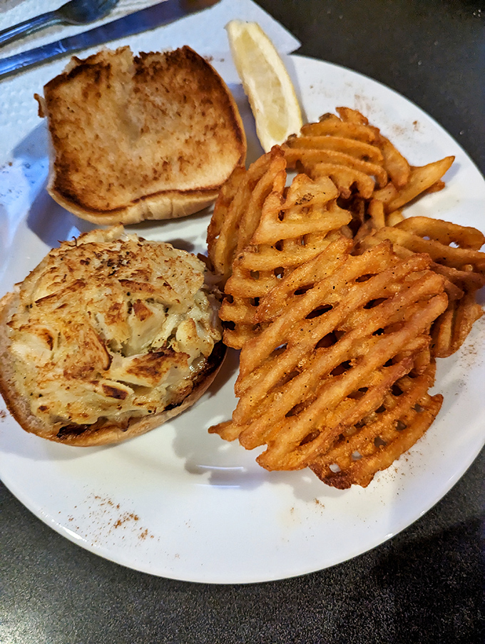 The humble sandwich, elevated to art form. That golden-brown crab cake nestled on a toasted bun with those signature waffle fries is weekend comfort on a weekday schedule.