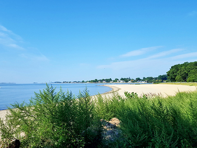 The gentle curve of shoreline whispers promises of summer days where time slows down and worries wash away with the tide.